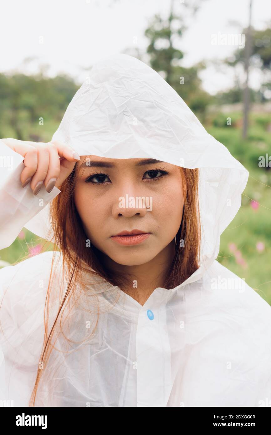 close up woman wear raincoat stand in the rainforest Stock Photo - Alamy