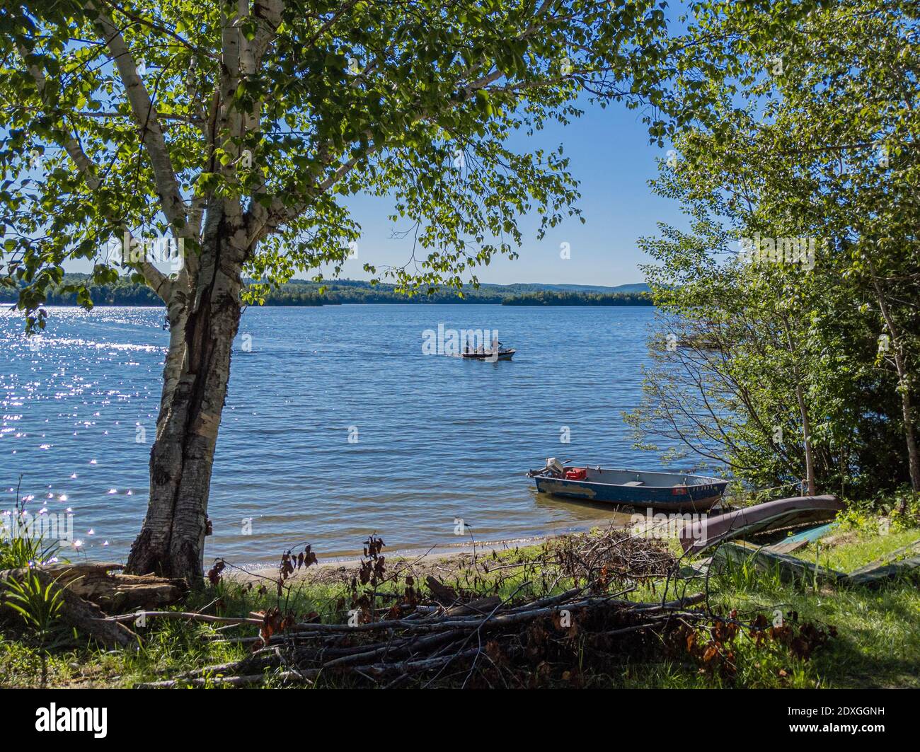 Two people fishing near dock on edge of lake in Quebec, Canada Stock ...