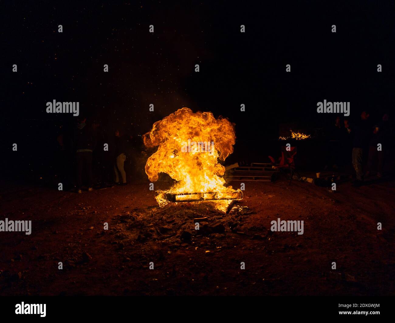 Ball of fire erupting from small campfire at night Stock Photo - Alamy