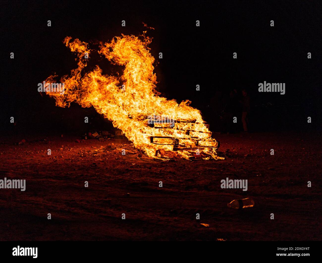 Large flame erupting from small campfire at night Stock Photo - Alamy