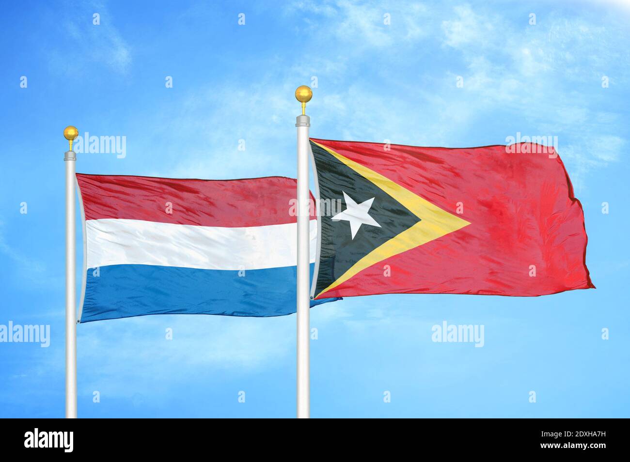 Netherlands and Timor-Leste East Timor two flags on flagpoles and blue ...