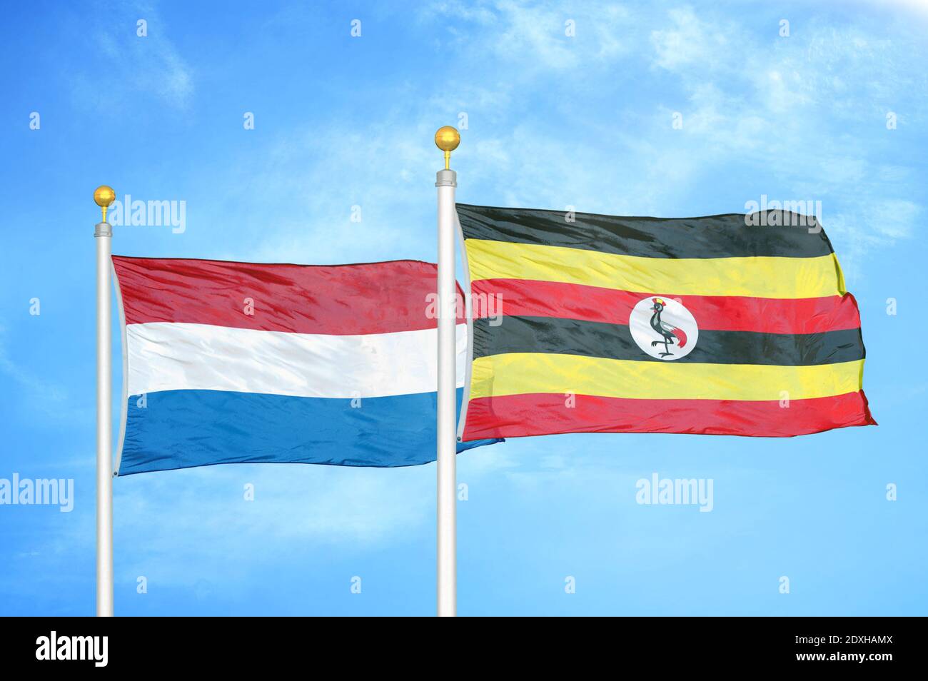 Netherlands and Uganda two flags on flagpoles and blue sky Stock Photo ...