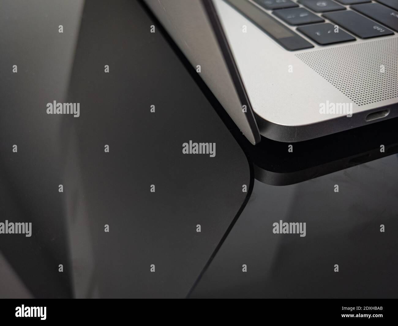 Abstract view of laptop reflecting on black surface Stock Photo - Alamy