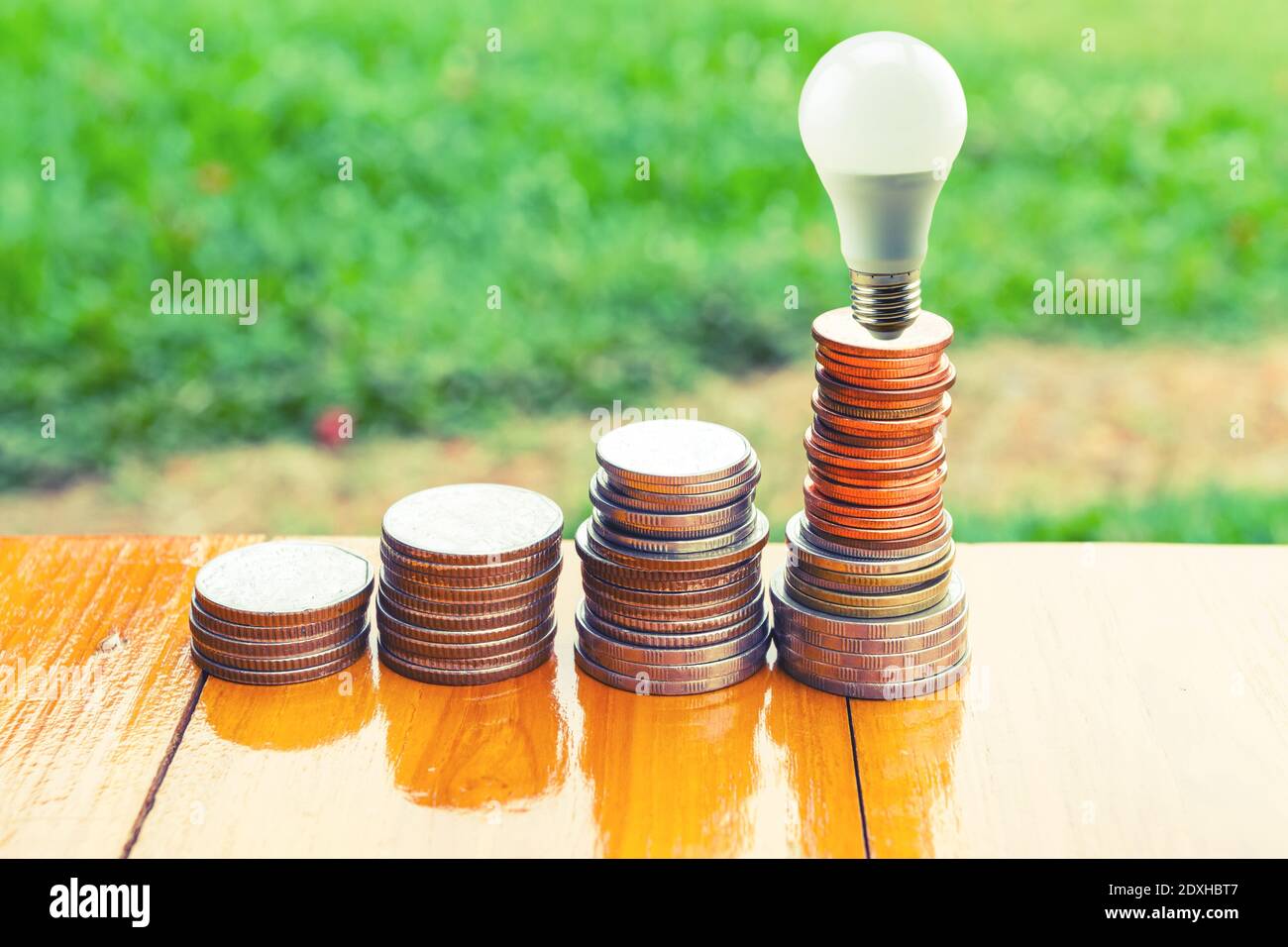 Money growing concept,Business success concept,lamp on pile of coins ...