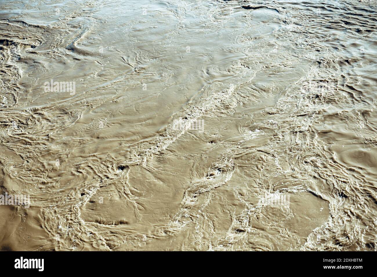 view of overflowing river with water and mud at high speed Stock Photo ...