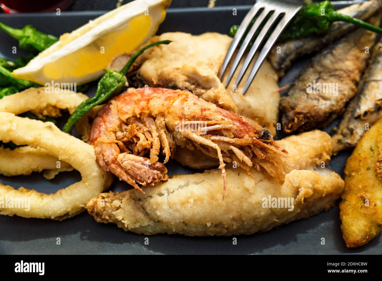 close up of dishes with golden fried fish and wine Stock Photo - Alamy