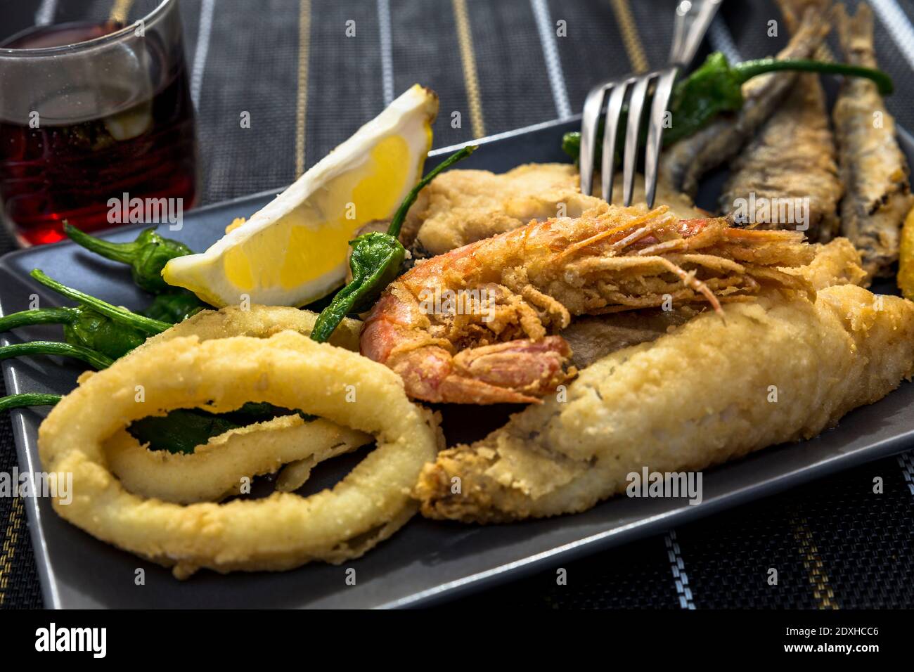 close up of dishes with golden fried fish and wine Stock Photo - Alamy