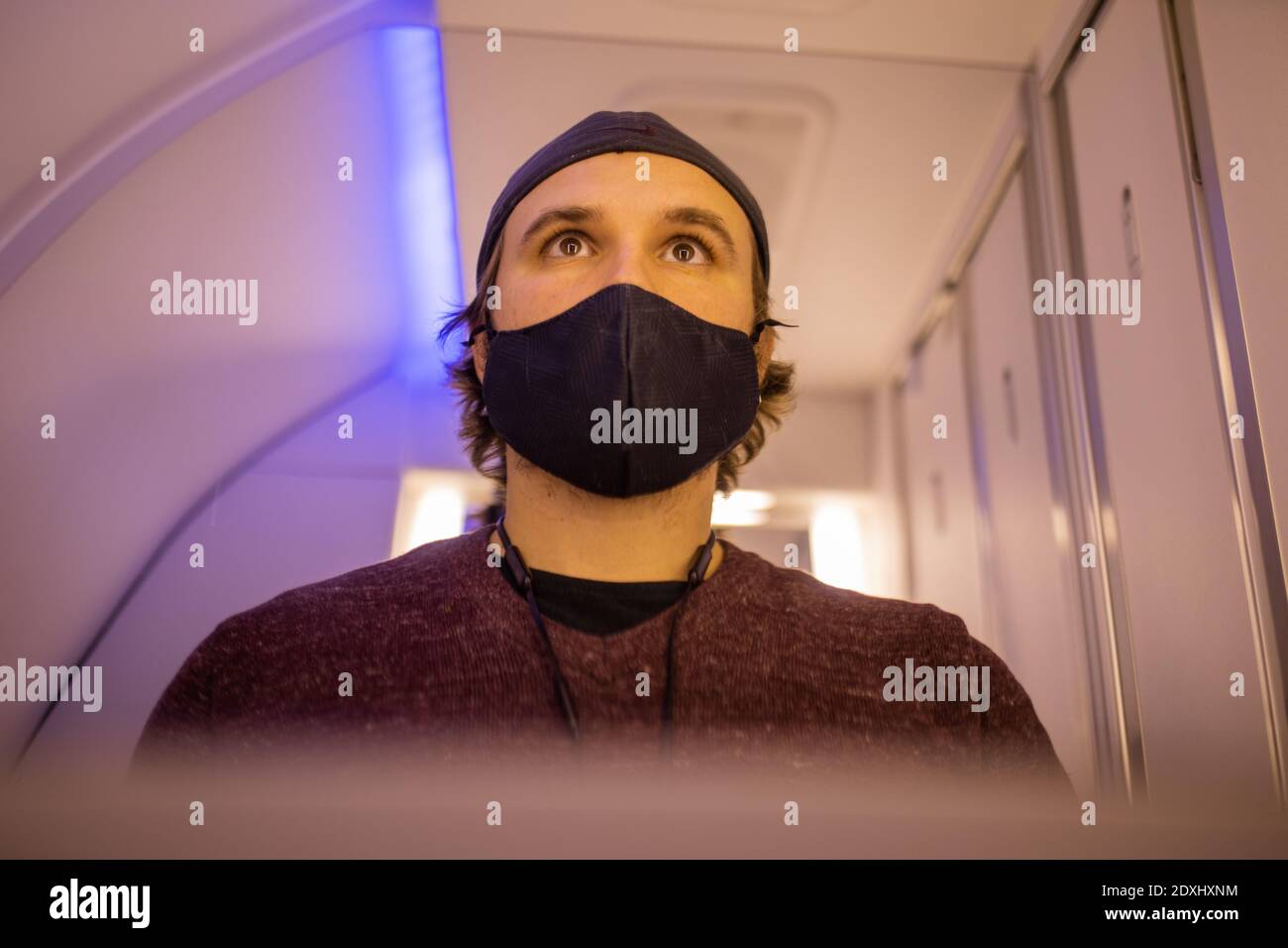 Self-portrait of a man wearing face mask in airplane bathroom Stock ...