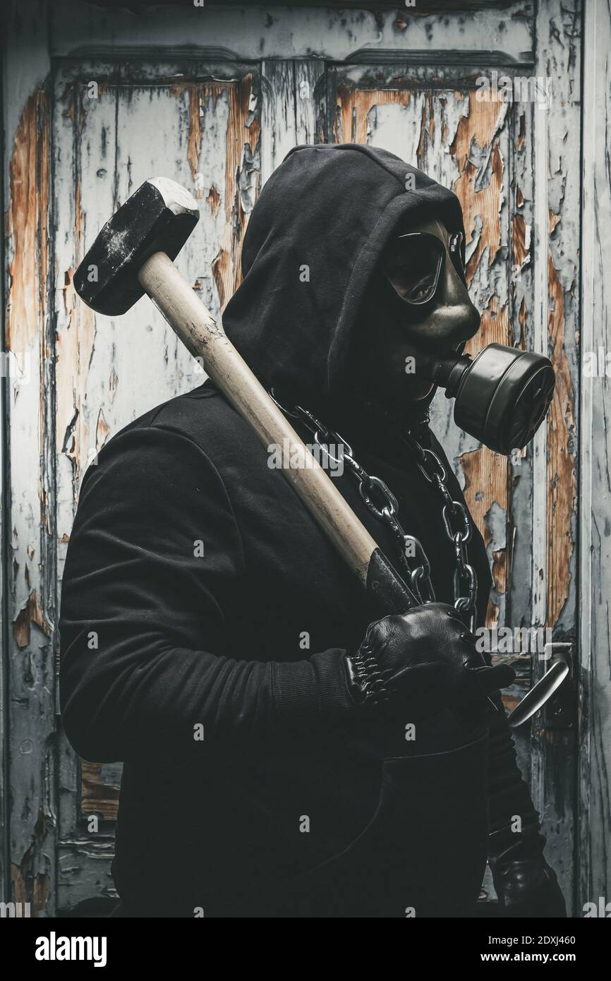 Man with gas mask and a hammer in machine room. Nuclear, Biological and ...
