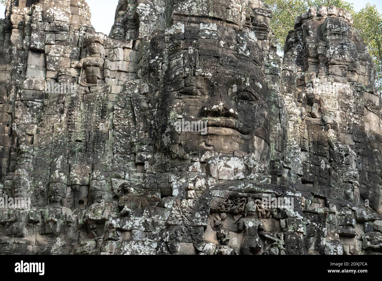 Large face carved into the wall of a temple in Angkor Thom Stock Photo ...