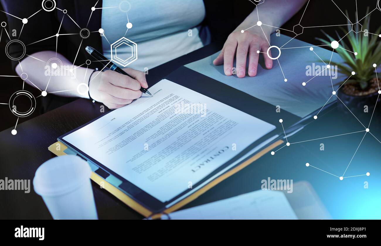 Businesswoman signing a contract; light effect Stock Photo - Alamy