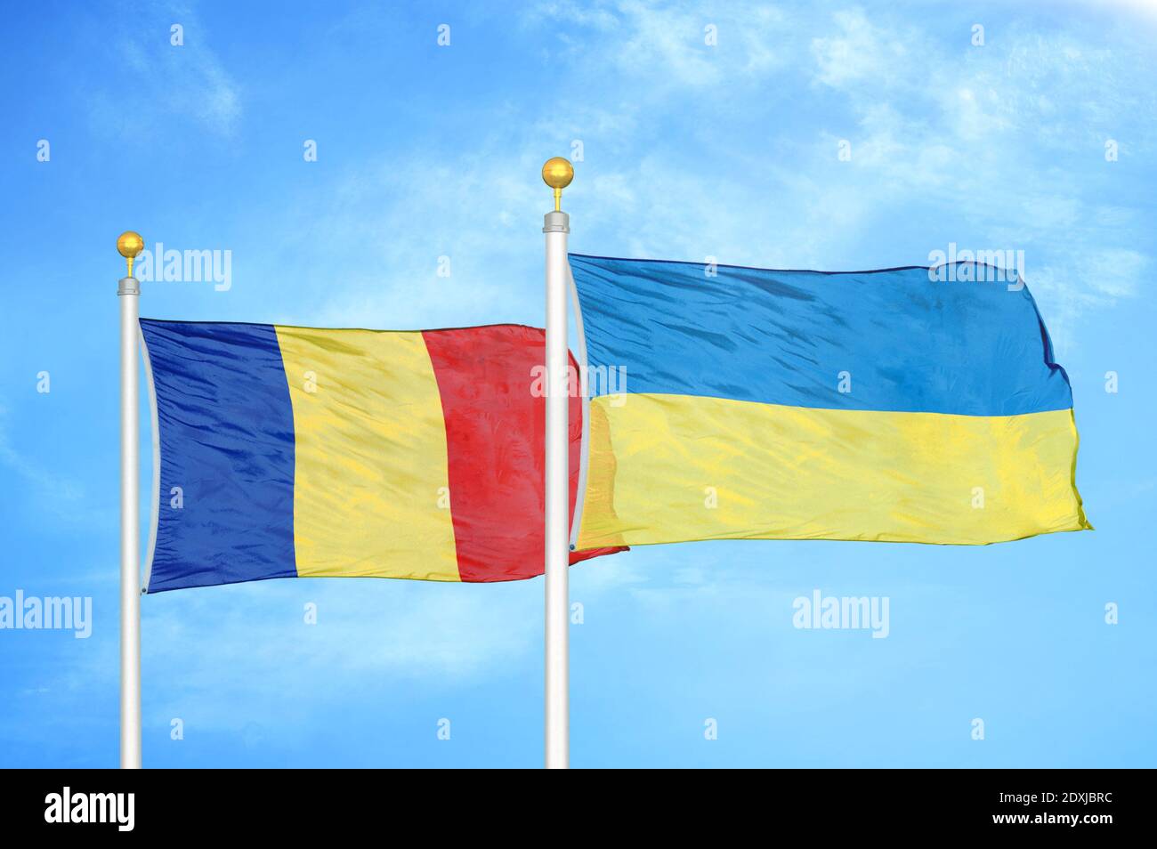 Romania and Ukraine two flags on flagpoles and blue sky Stock Photo - Alamy