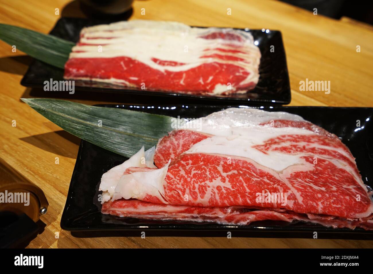 Fresh and raw sliced Japanese Wagyu beef decorated on black ceramic ...