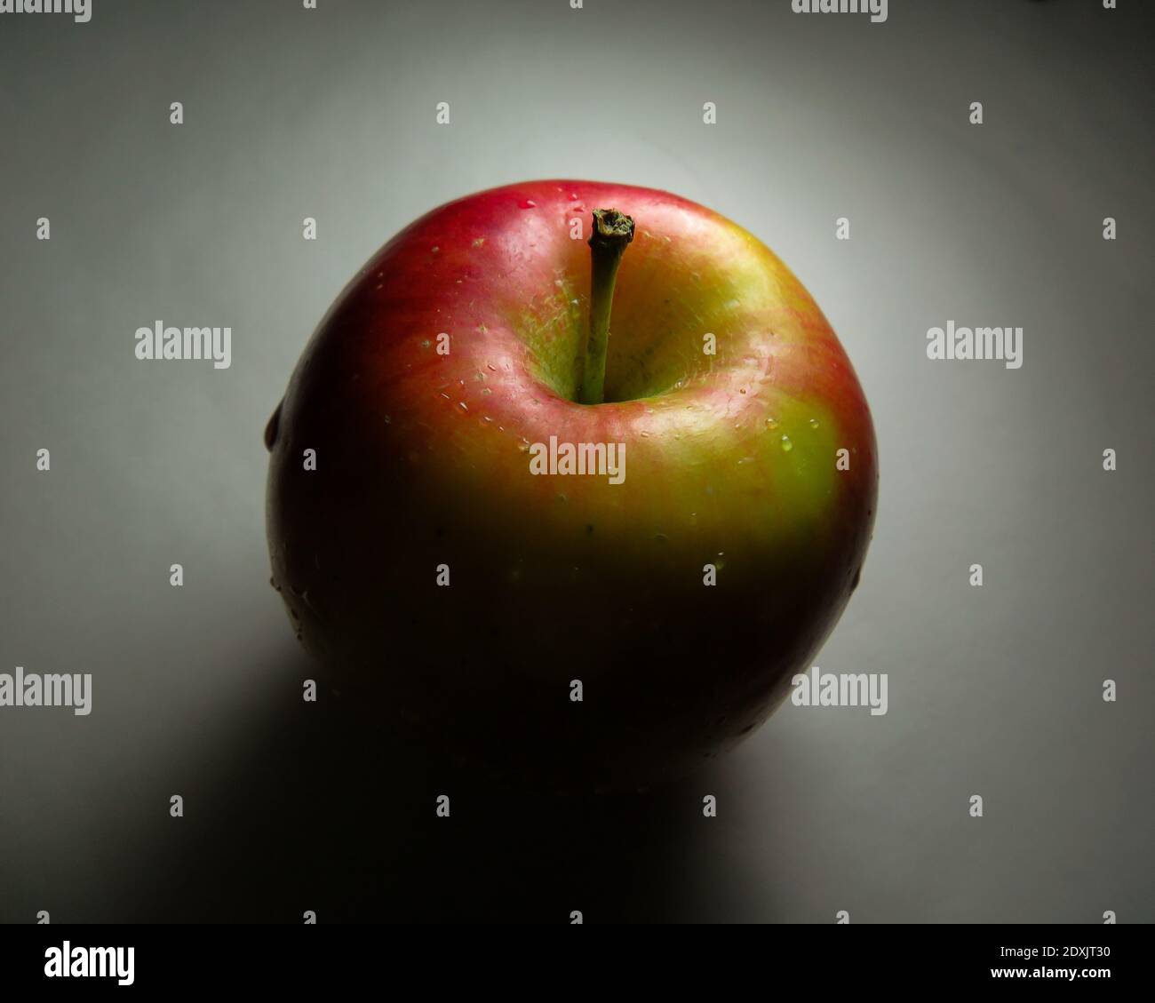 Red Apple On A Light Background With The Reflected Shadow Stock Photo ...