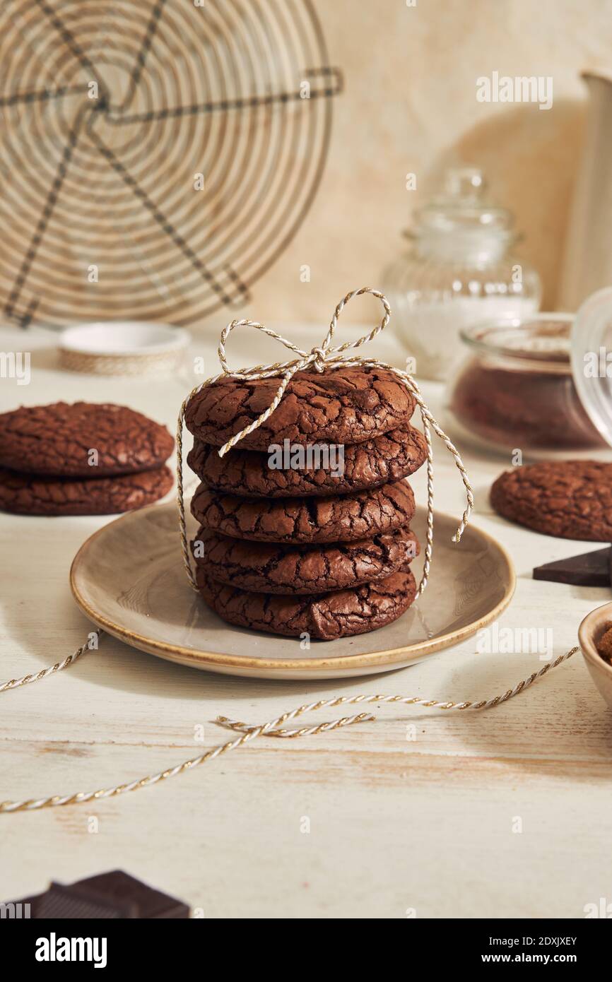 A vertical shot of delicious fudge chocolate cookie with ingredients on ...