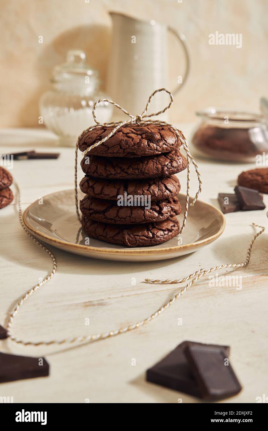 A vertical shot of delicious fudge chocolate cookie with ingredients on ...
