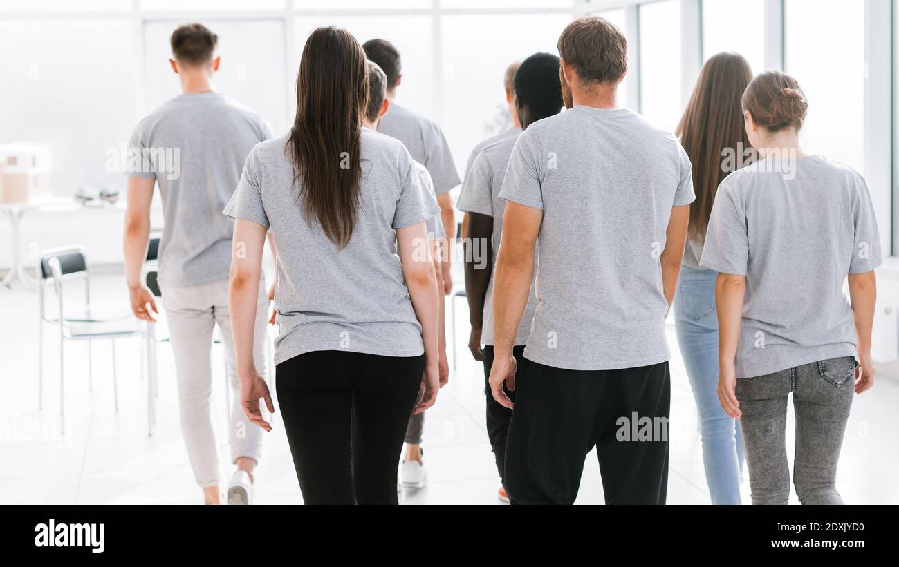 rear view. a group of young people standing in a bright room Stock ...