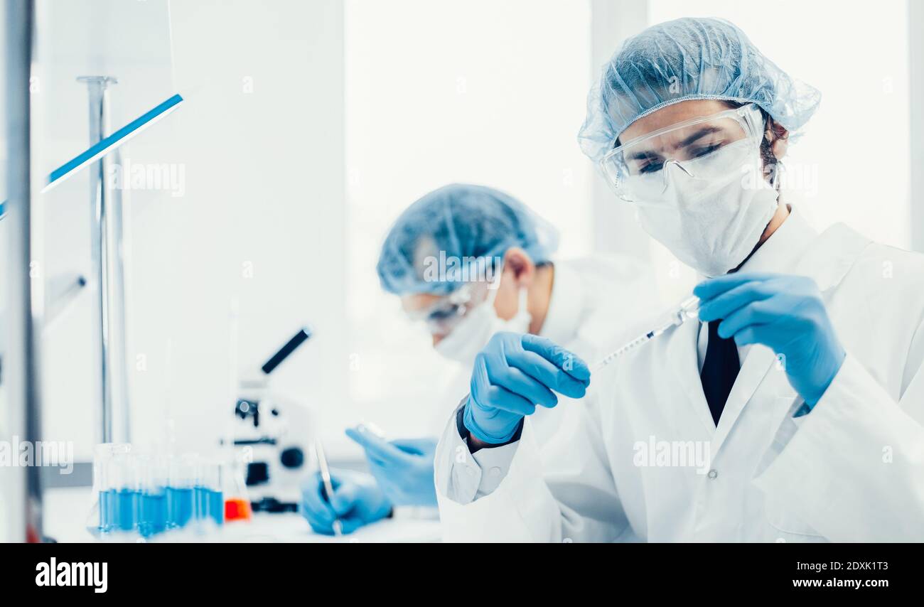close up. group of scientists sitting at a laboratory table Stock Photo ...
