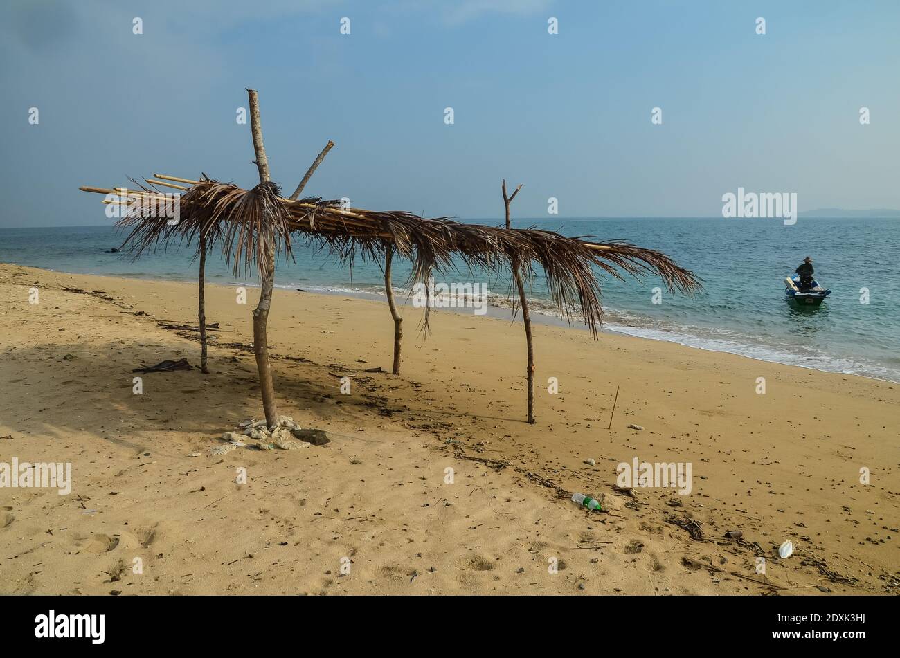 Shade made out f branches and palm leaves on the Gwa island beach ...