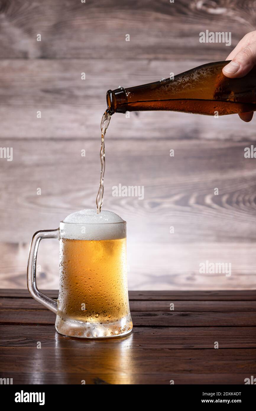 Hand pouring beer in glass hi-res stock photography and images - Alamy