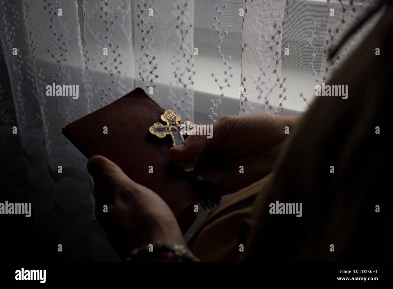 Close up of woman hands praying by the window. Praying hands holding ...