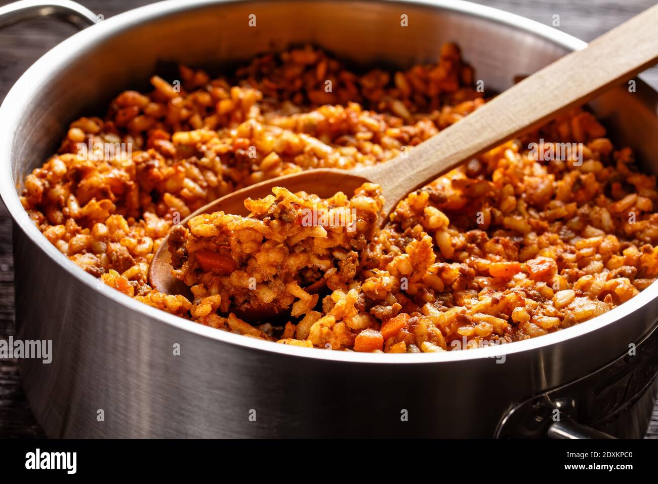 close-up of ground beef risotto bolognese in a metal stewpot with a ...