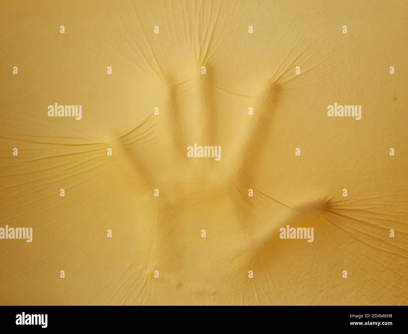 Handprint on yellow memory foam pillow Stock Photo - Alamy