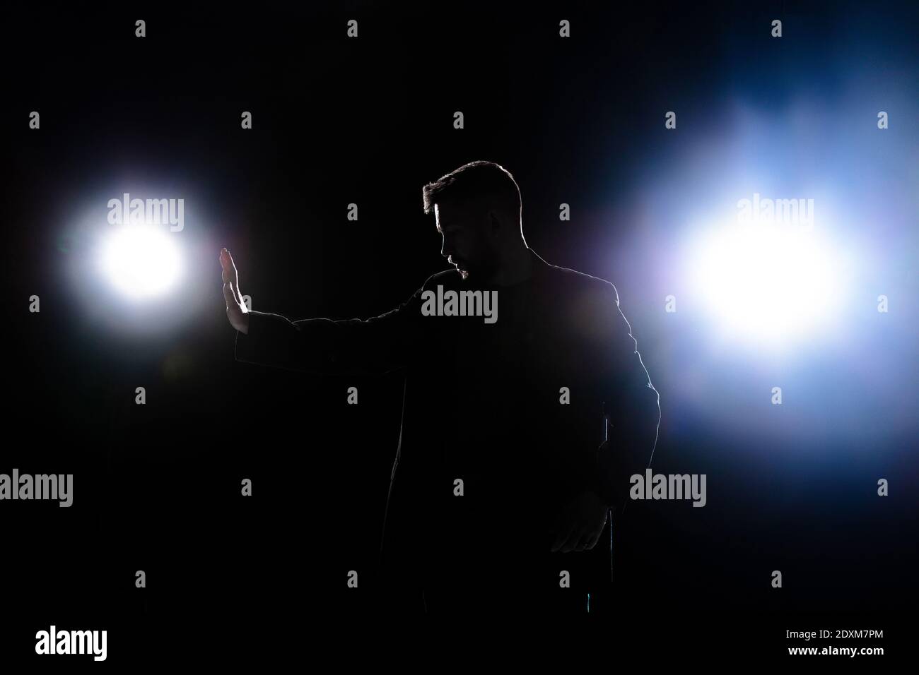 Silhouette of man protect himself isolated on dark background in ...