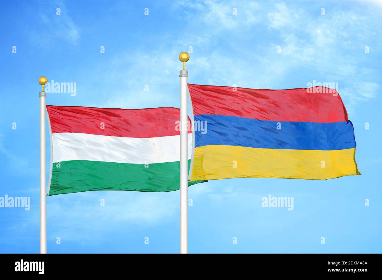 Hungary and Armenia two flags on flagpoles and blue cloudy sky Stock ...