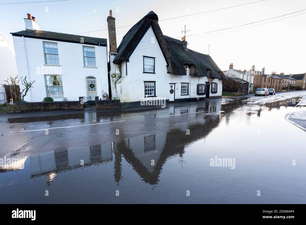 Willingham Cambridgeshire, UK. 24th Dec, 2020. A thatched cottage is ...