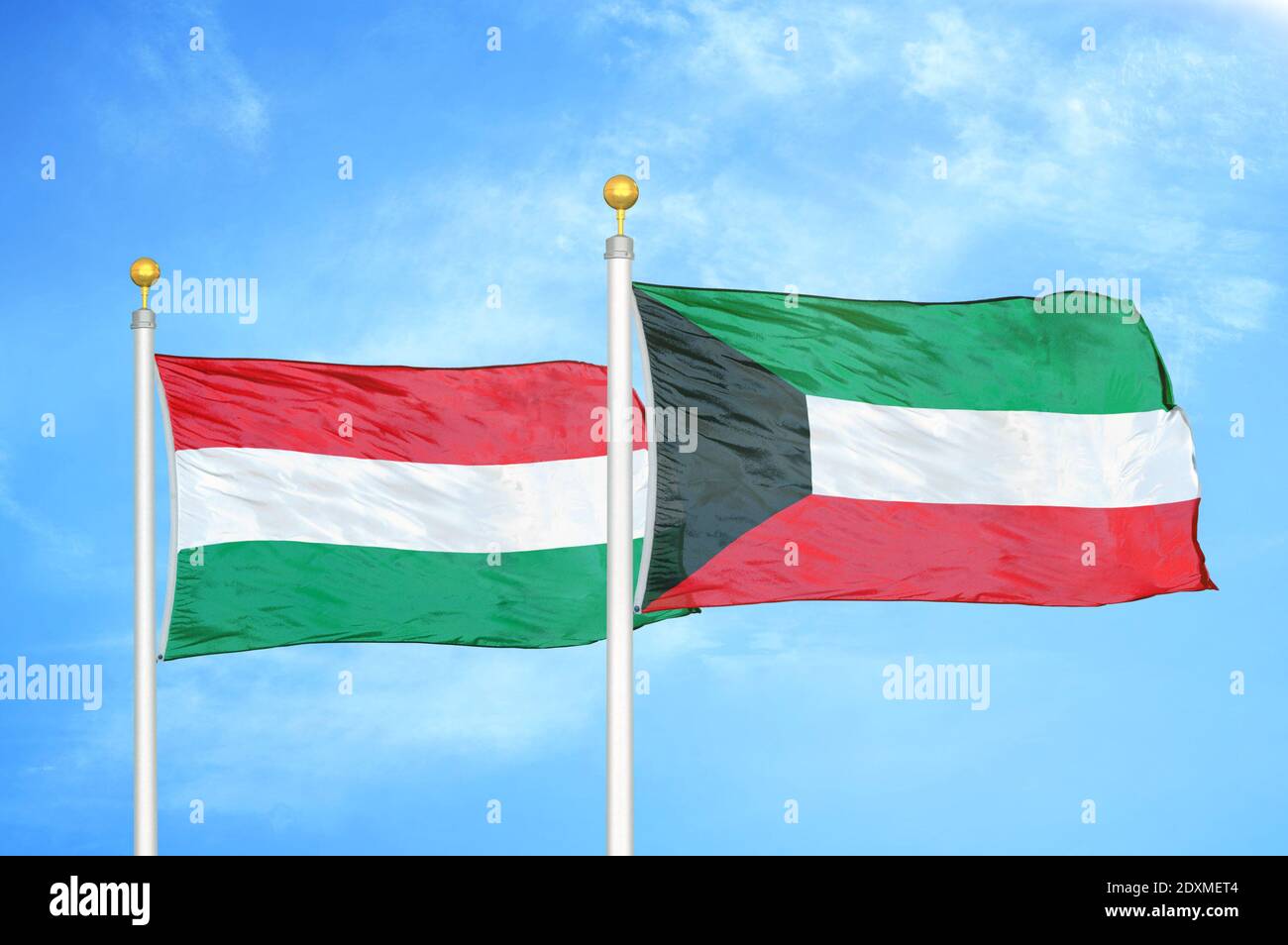 Hungary and Kuwait two flags on flagpoles and blue cloudy sky Stock ...