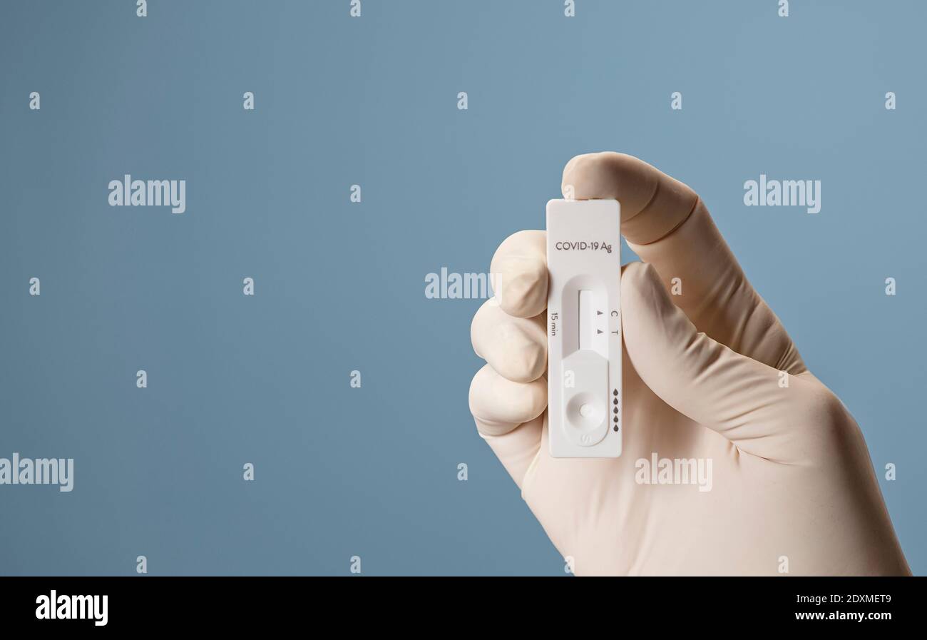 Doctor holding a test kit for viral disease, COVID-19 SARS-CoV-2 lab ...