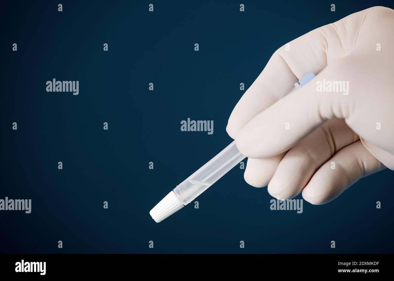 Laboratory scientist with vial and swab indoors performing a rapid ...