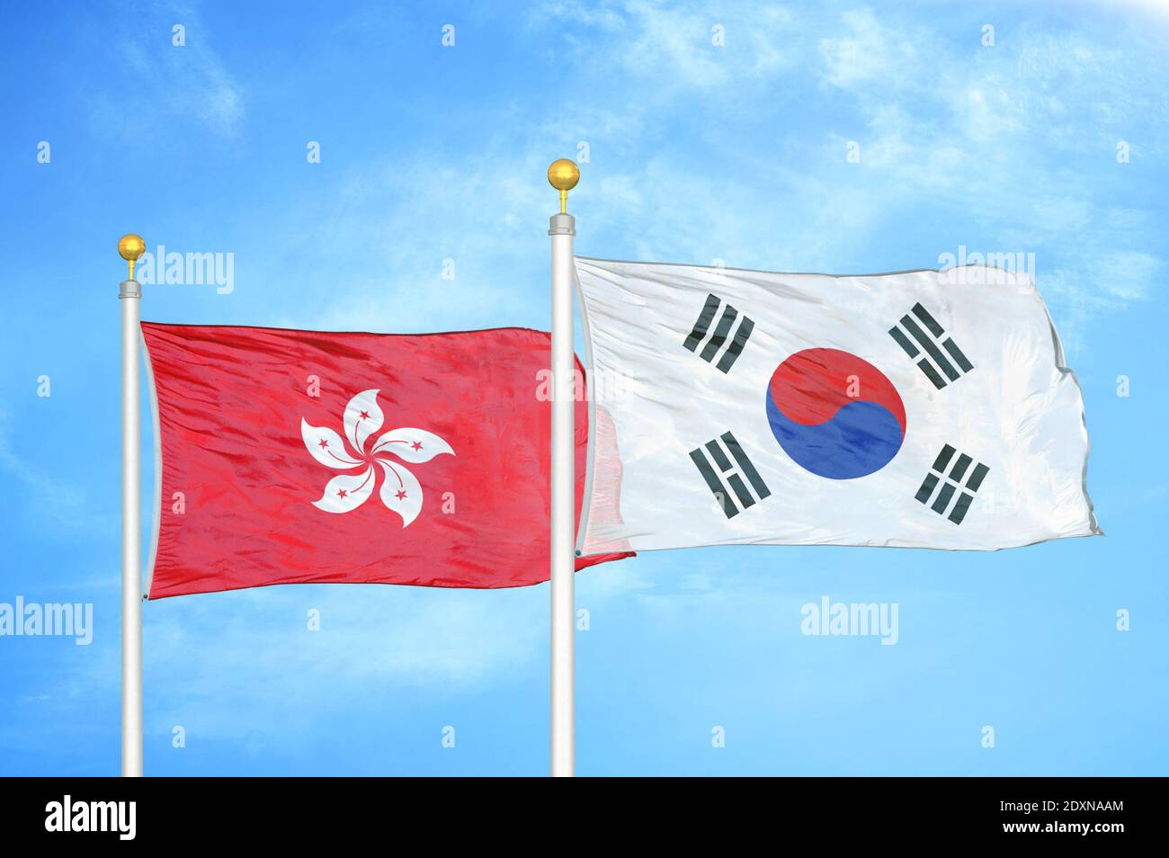 Hong Kong and South Korea two flags on flagpoles and blue cloudy sky ...