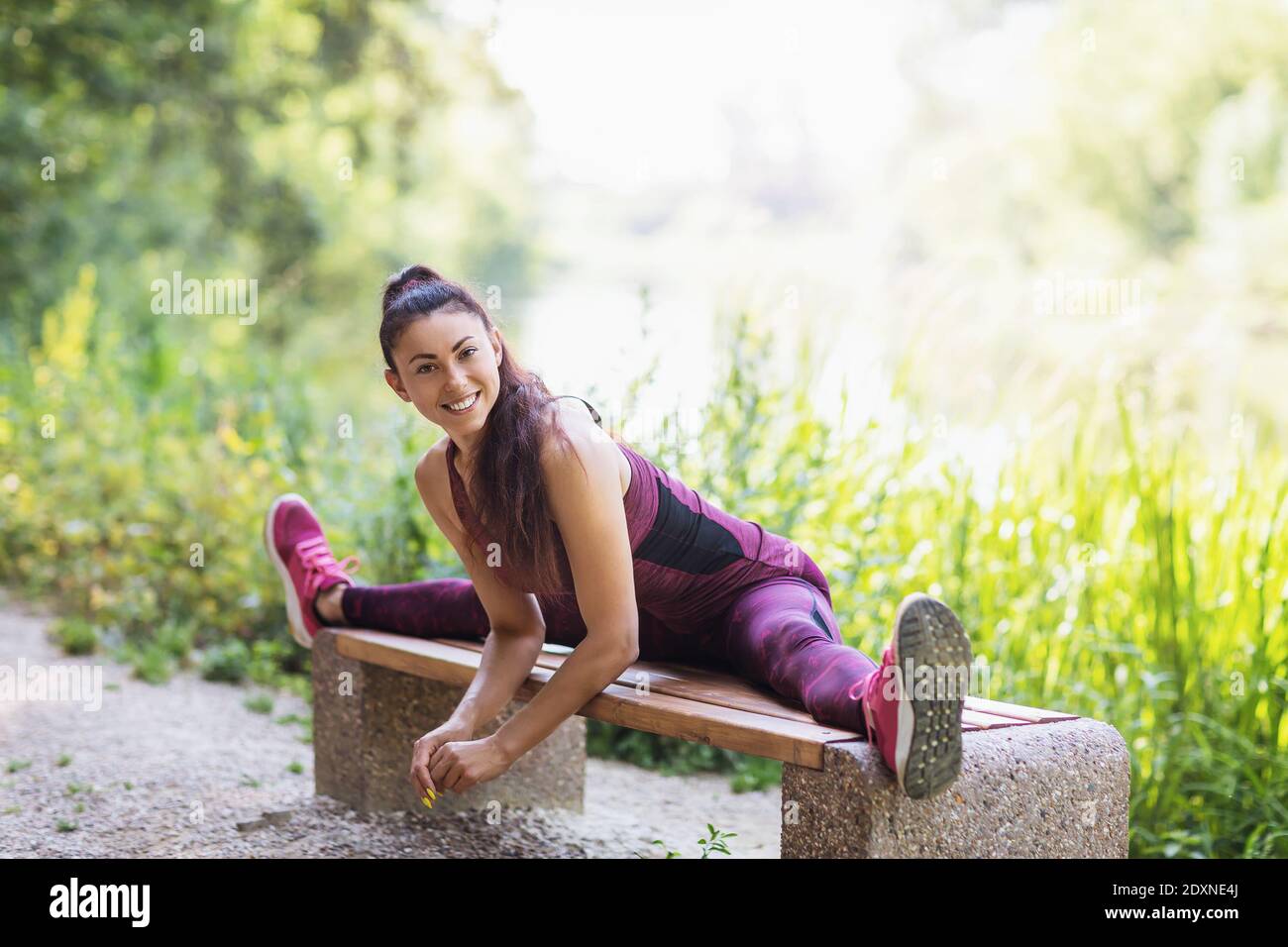 Woman stretching outdoors bench hi-res stock photography and images - Alamy