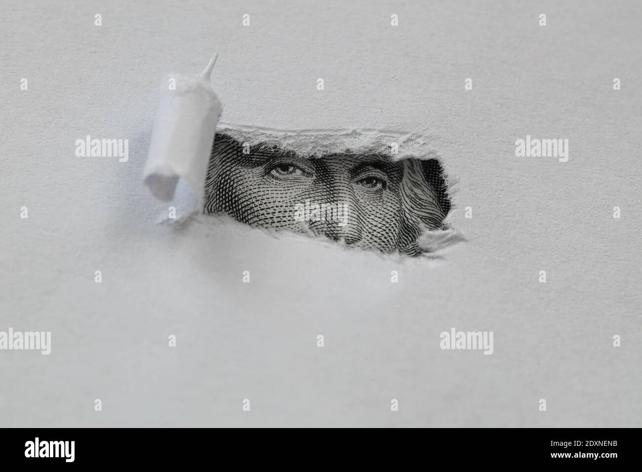 George Washington macro peeking through torn white paper Stock Photo ...