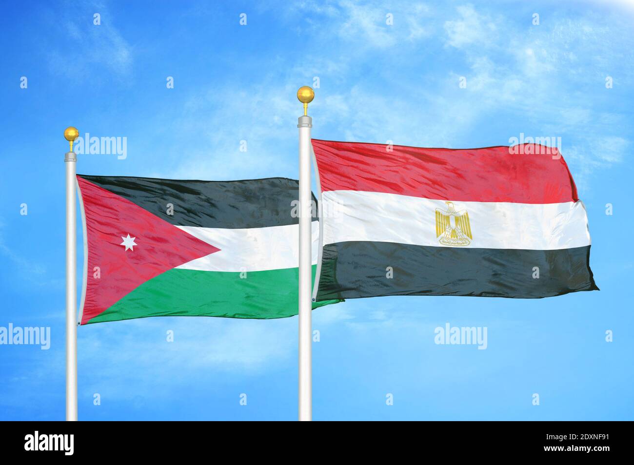 Jordan and Egypt two flags on flagpoles and blue cloudy sky Stock Photo ...