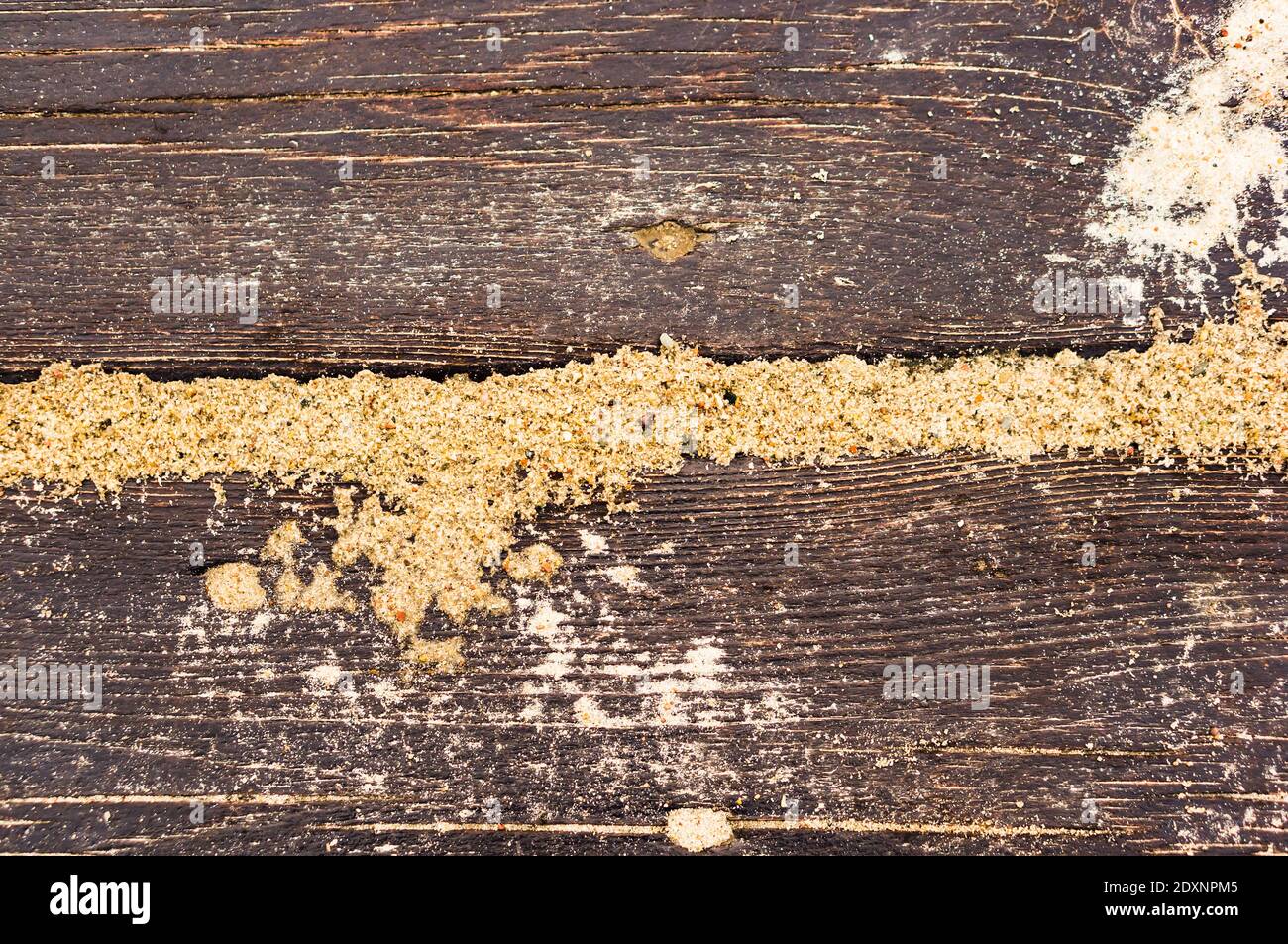 A high angle shot of sand filling the cracks of a wooden sandbox Stock ...