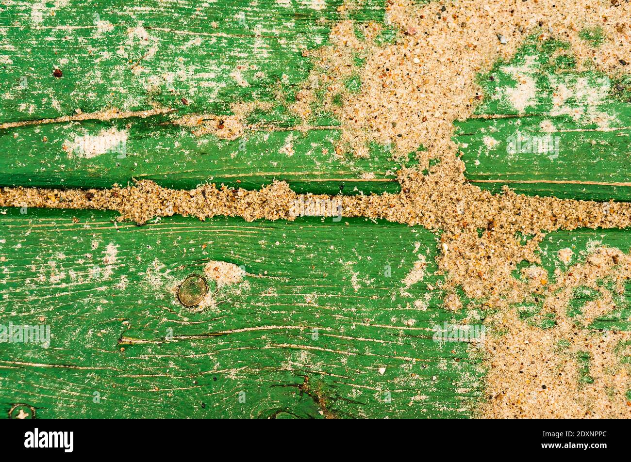 A high angle shot of sand filling the cracks of a wooden sandbox Stock ...