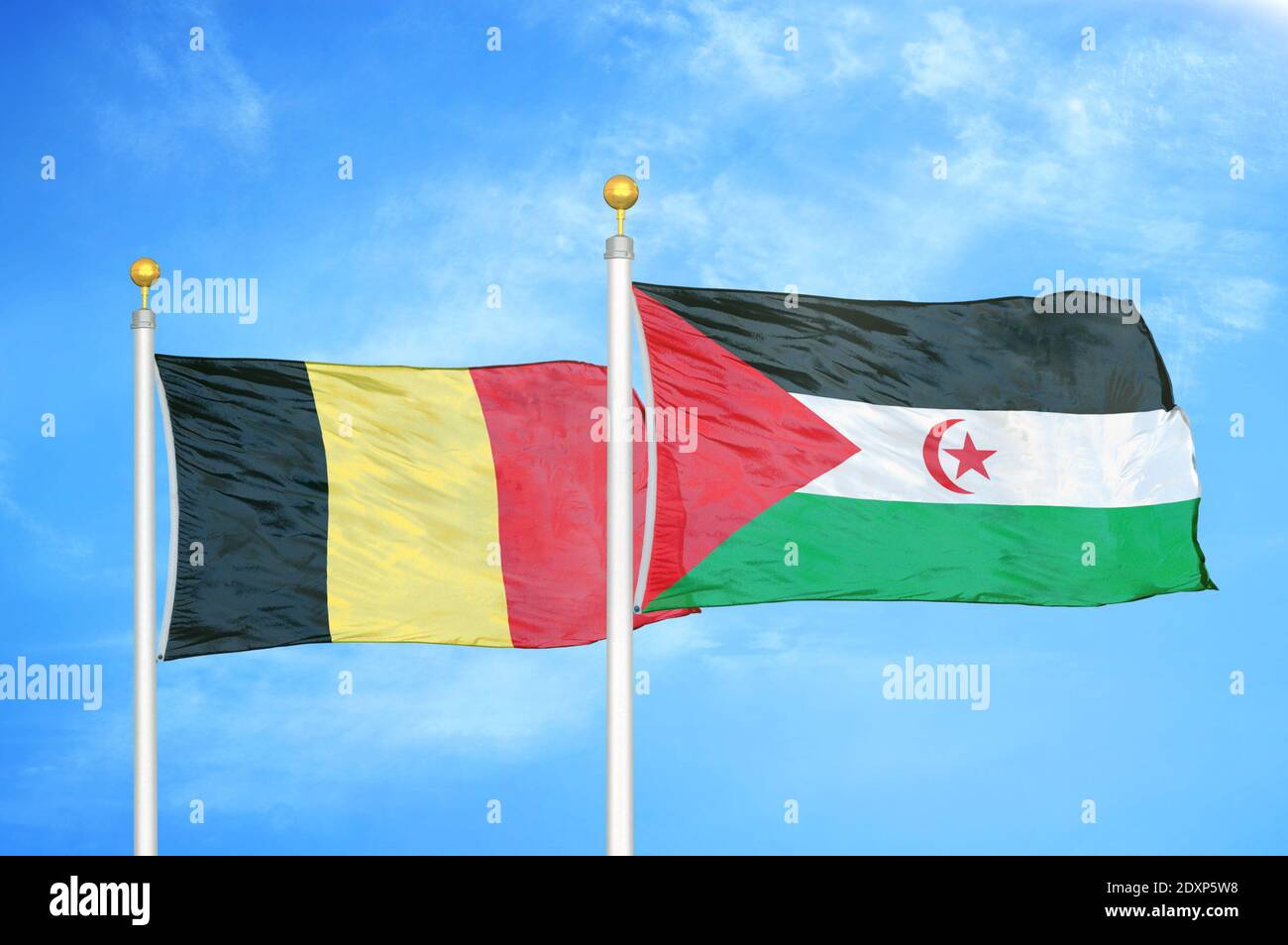 Belgium and Western Sahara two flags on flagpoles and blue cloudy sky ...