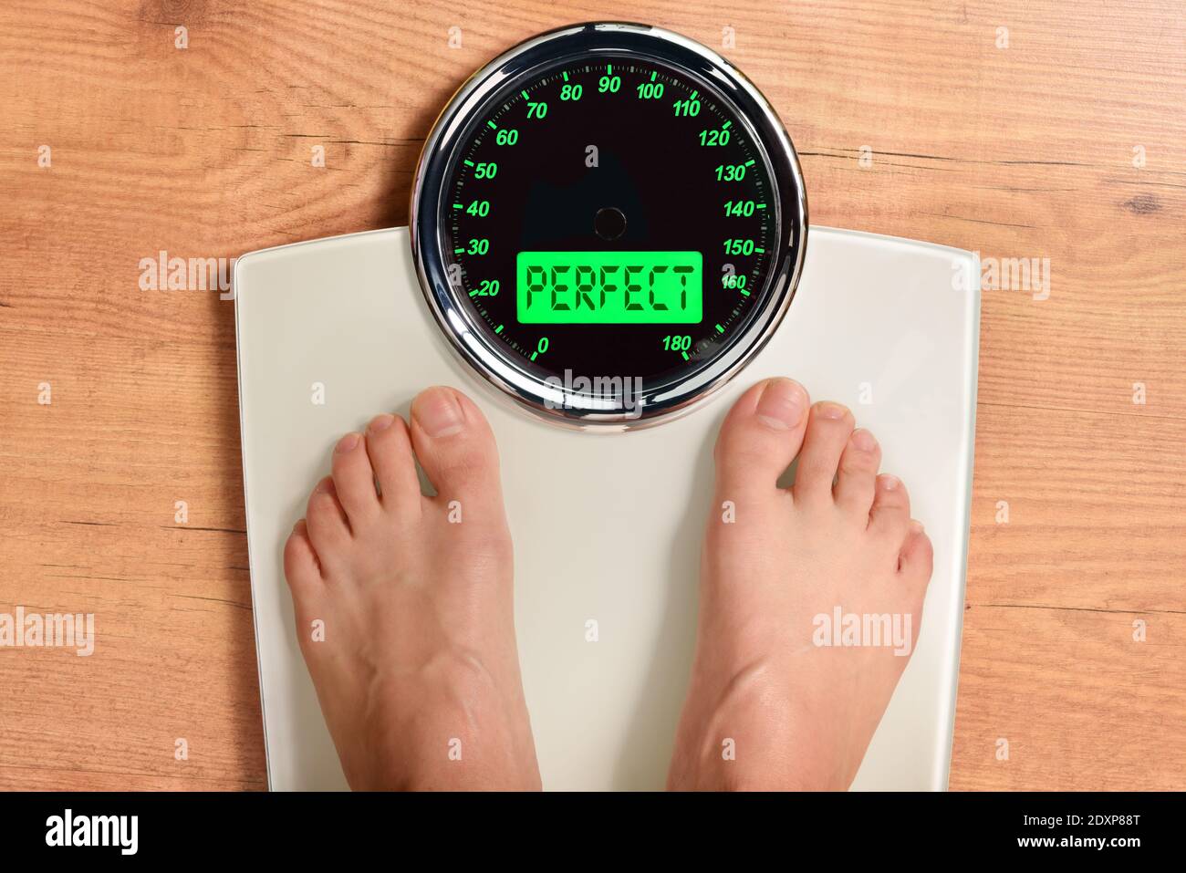 Ideal weight concept with feet being weighed on a scale and perfect ...