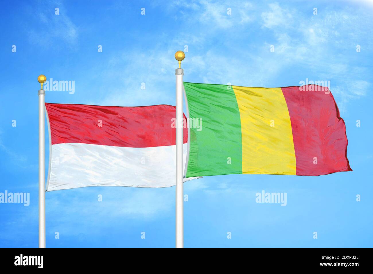 Indonesia and Mali two flags on flagpoles and blue cloudy sky Stock ...