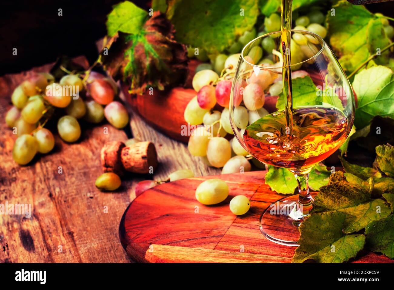 Cognac Pour In Glass, Grapes And Vine, Vintage Wood Background, Selective Focus Stock Photo - Alamy