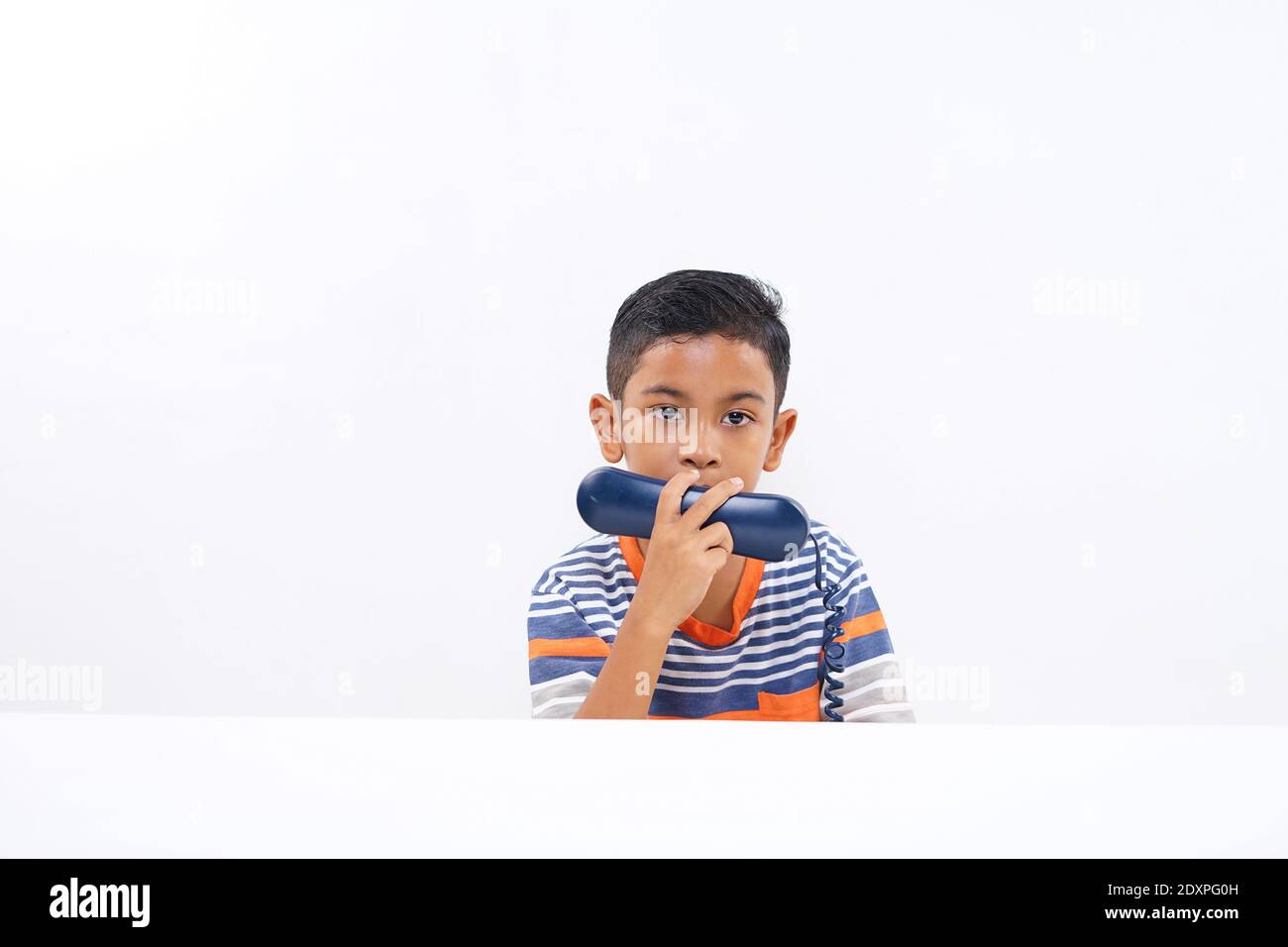 Portrait Of Boy Holding Telephone Receiver Against White Background ...