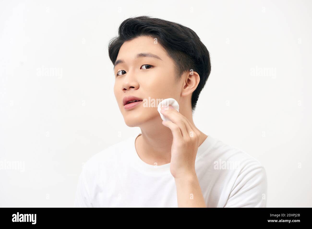 A young man looks after the skin of the face, a person without acne ...