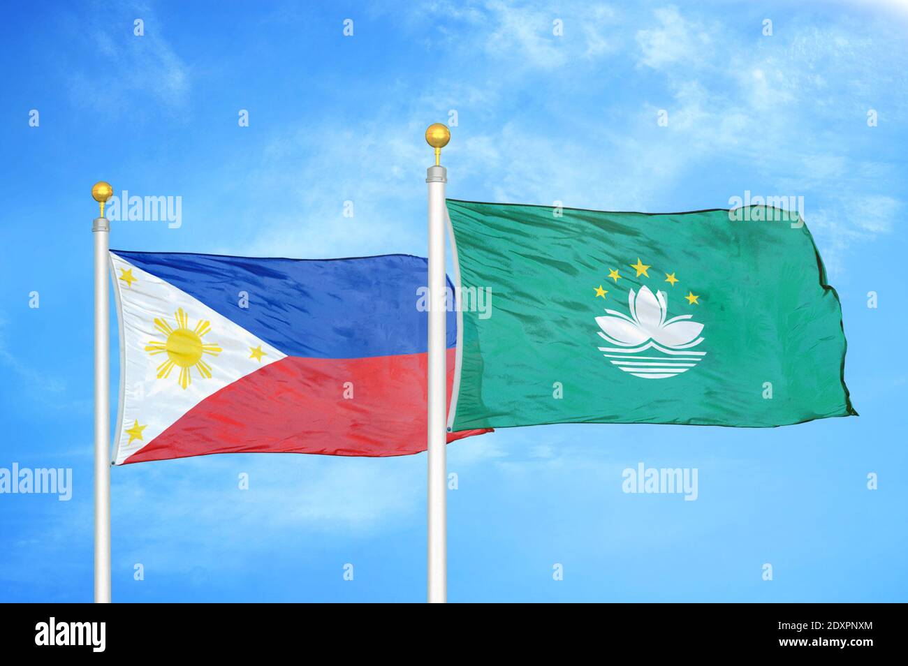 Philippines and Macau two flags on flagpoles and blue cloudy sky Stock ...