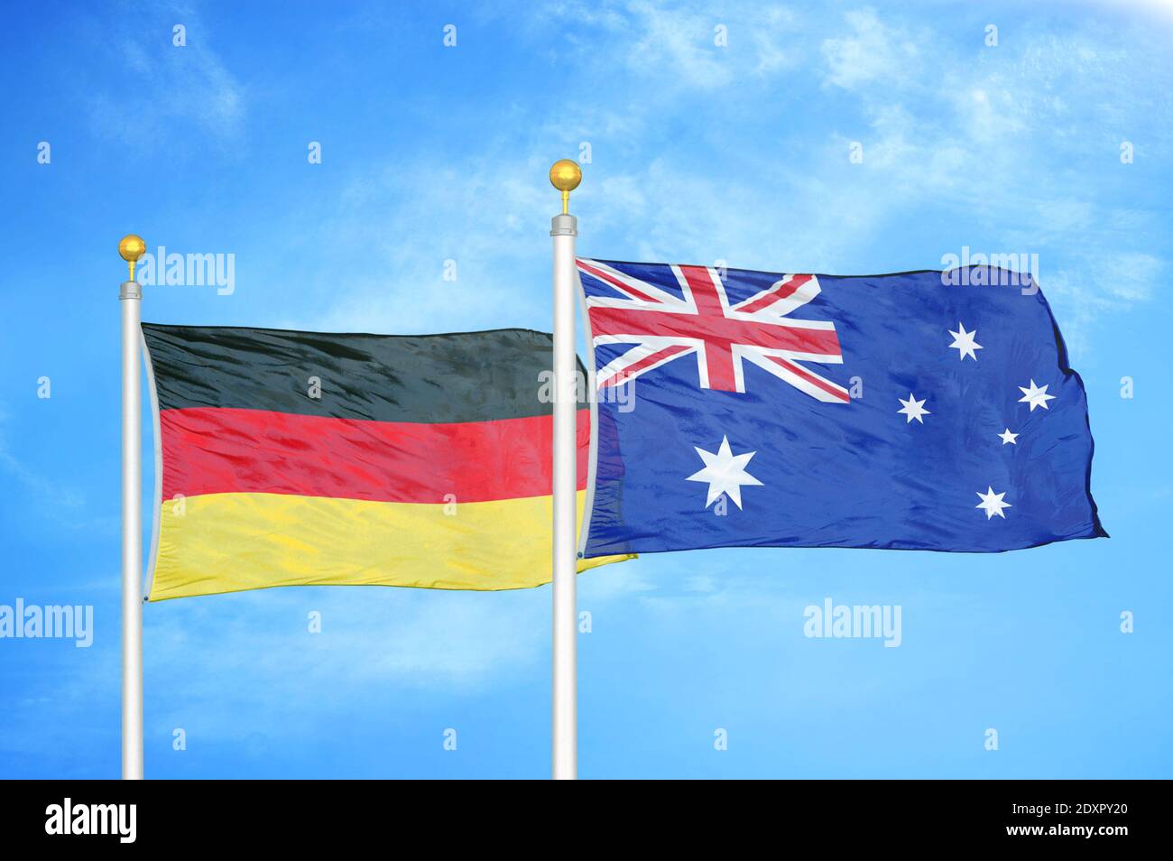 Germany and Australia two flags on flagpoles and blue cloudy sky Stock ...