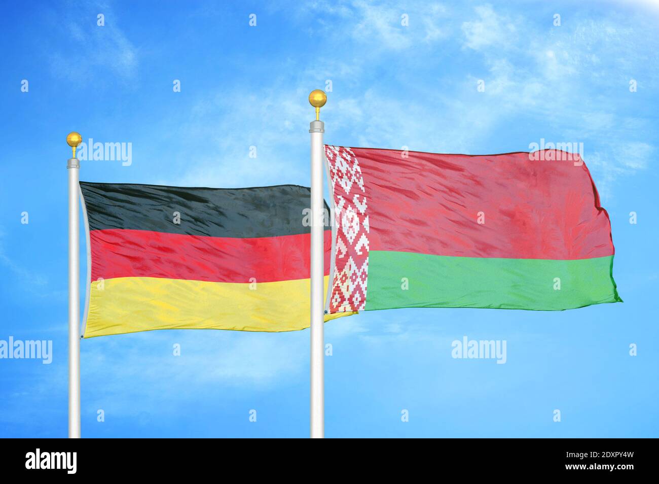 Germany and Belarus two flags on flagpoles and blue cloudy sky Stock ...