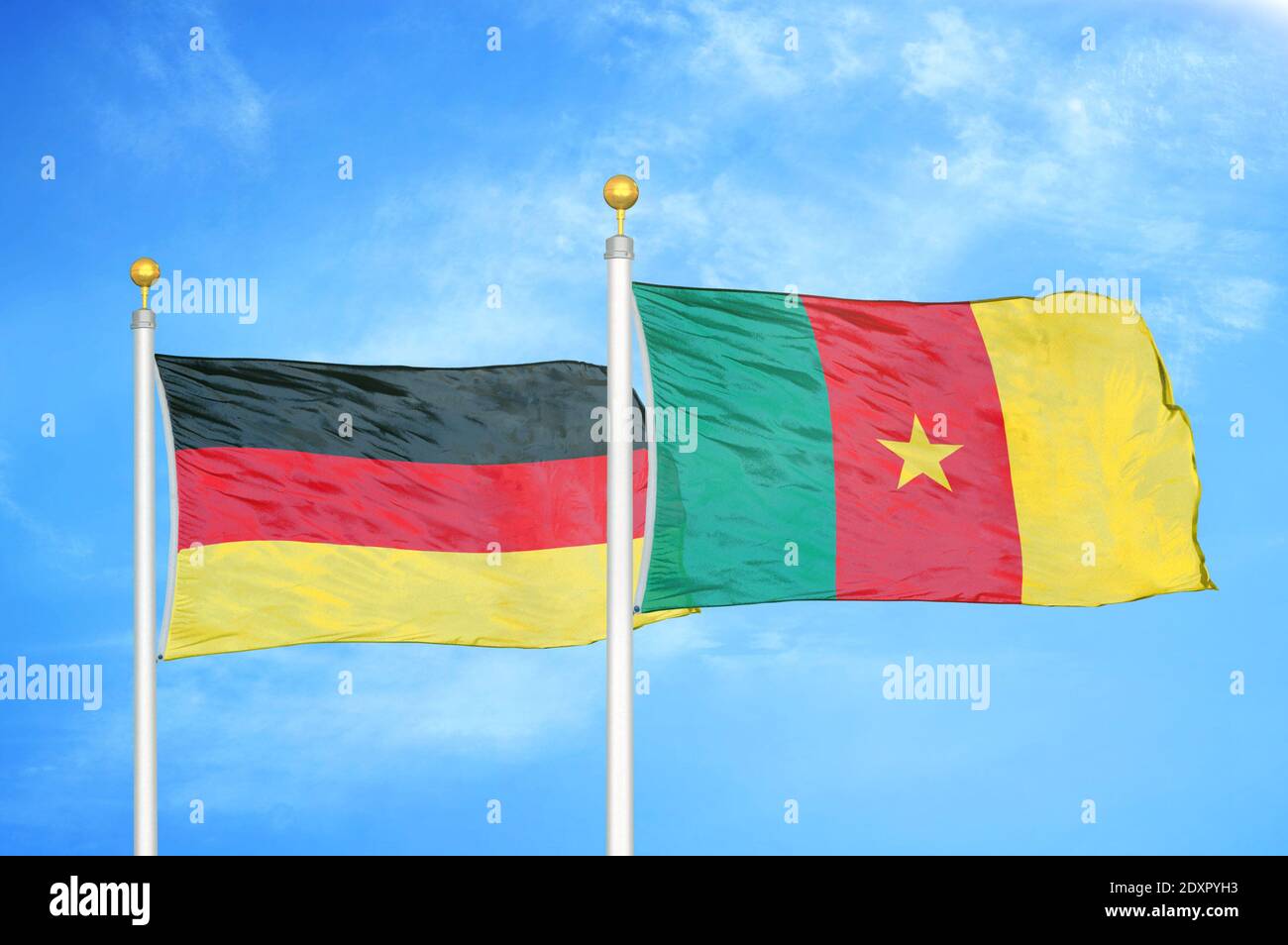 Germany and Cameroon two flags on flagpoles and blue cloudy sky Stock ...