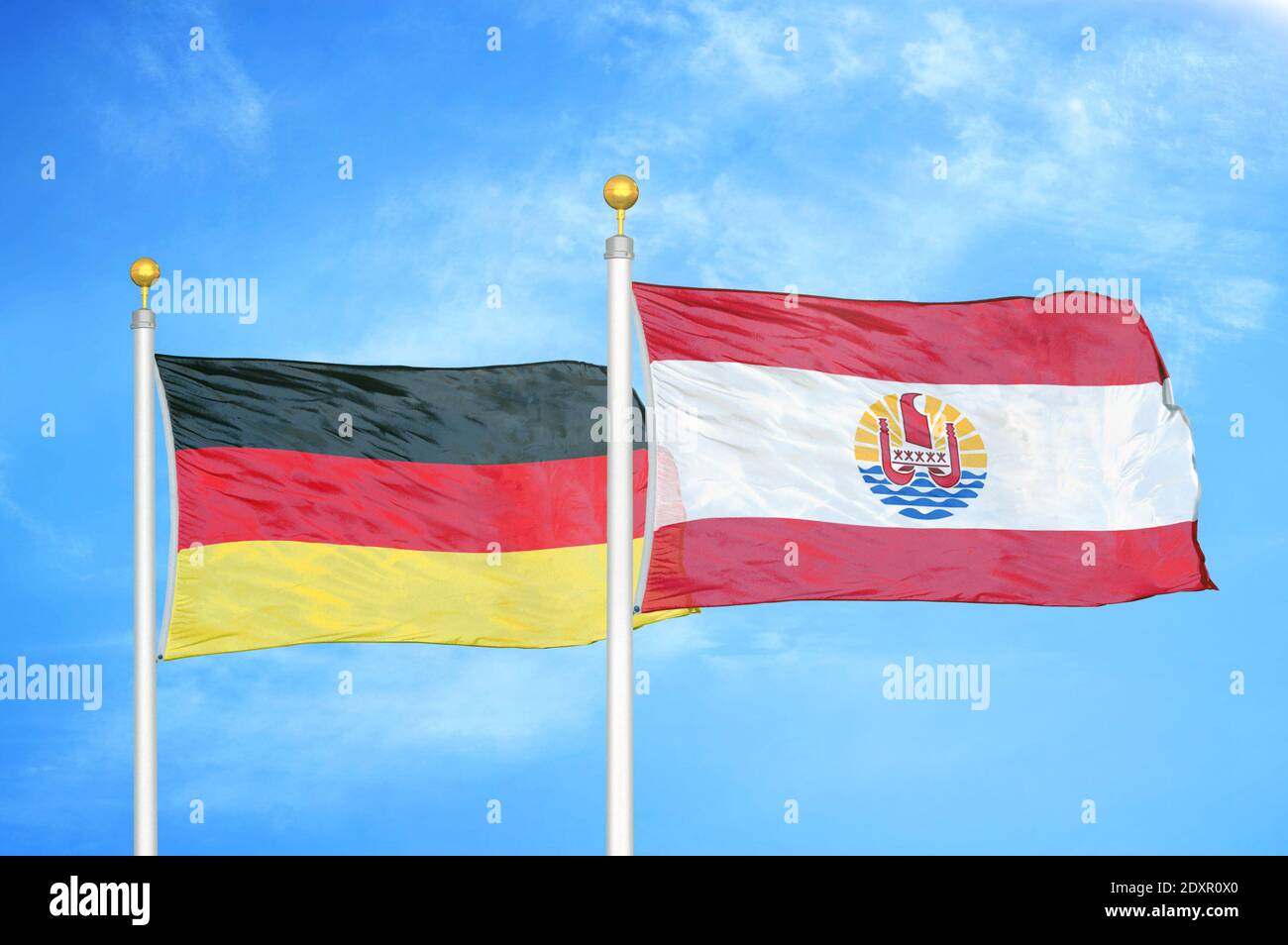 Germany and French Polynesia two flags on flagpoles and blue cloudy sky ...